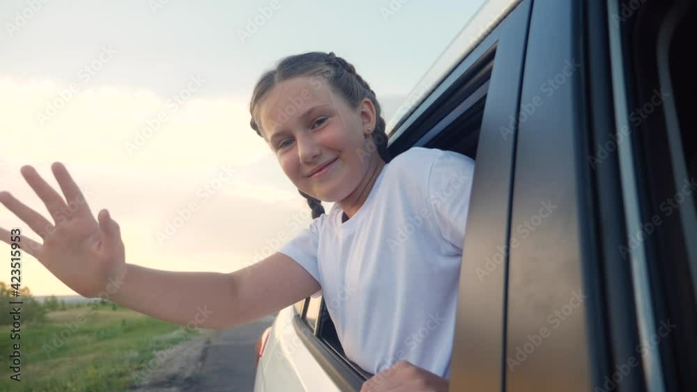 happy girl kid child leaned out lifestyle of a car window waving hand ...