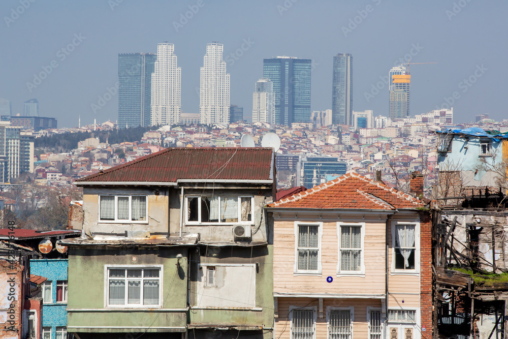 Front view, old houses standing in front of luxury and modern building ...
