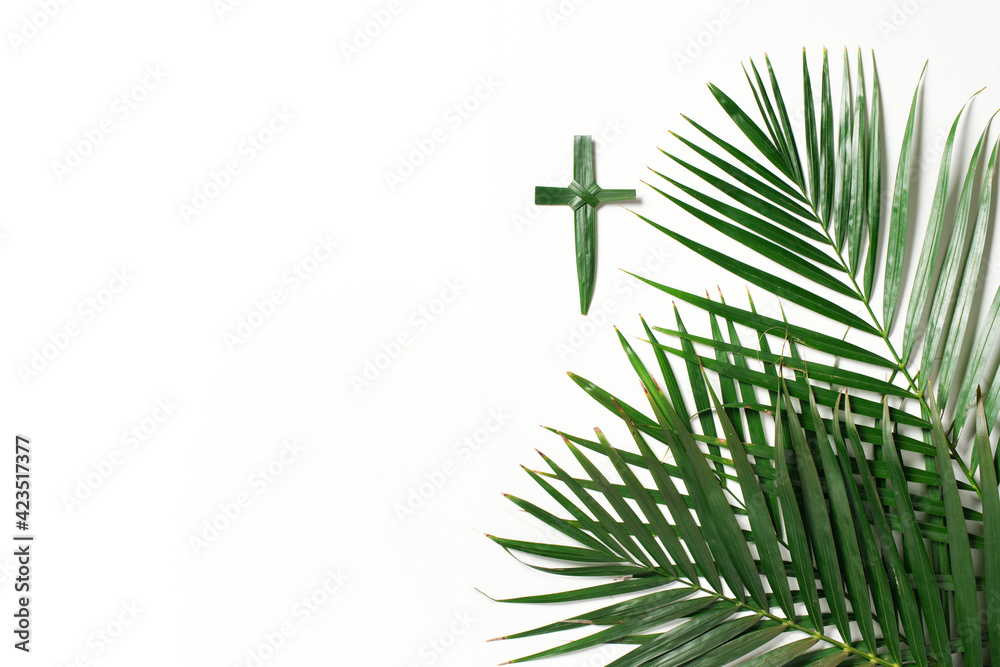 Palm Sunday concept. Cross made of palm and tropical leaves isolated on ...