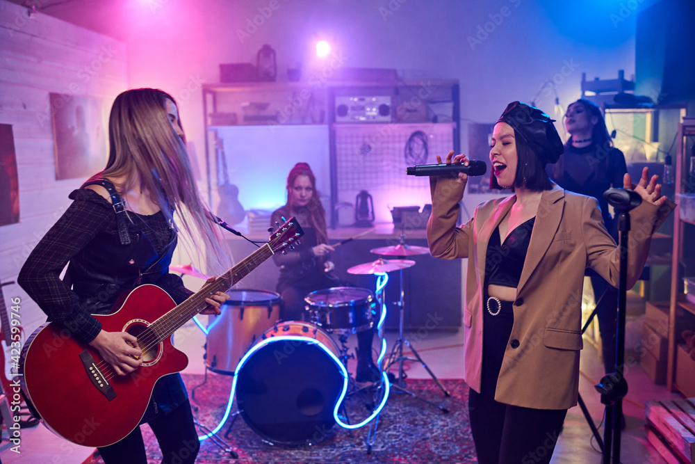 Music female band playing on musical instruments and performing in the ...