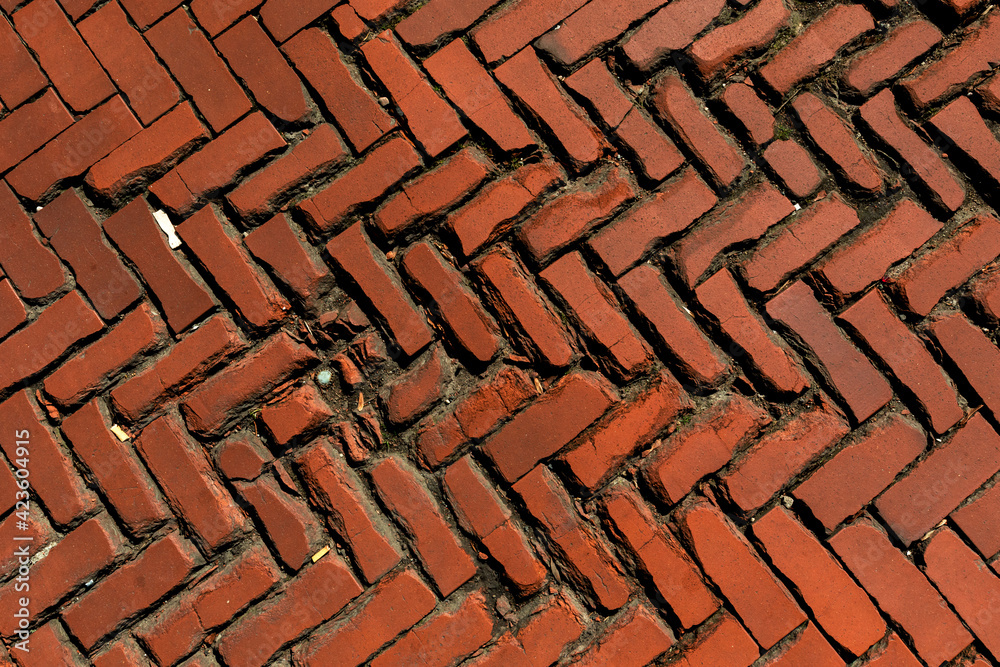 Old weathered and broken chipped brick road from naturally shiny brick ...