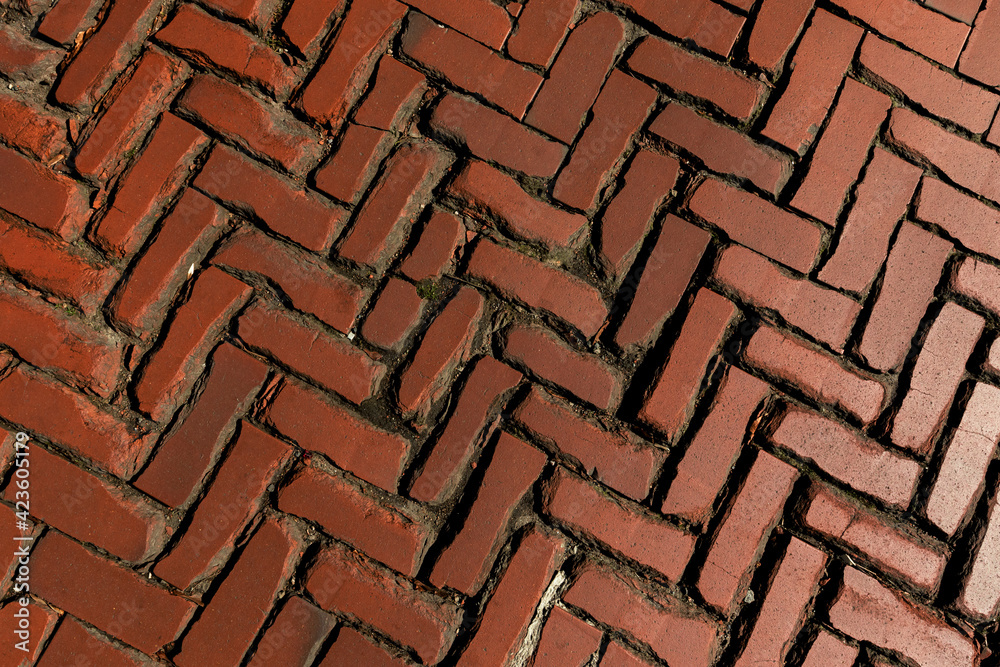 Old weathered and broken chipped brick road from naturally shiny brick ...