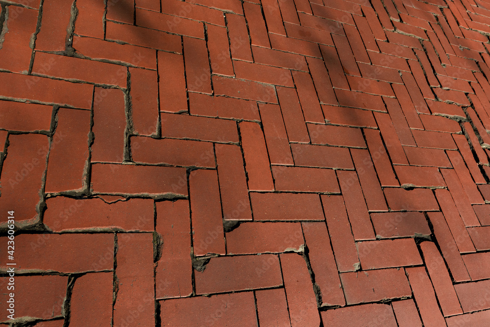 Old weathered and broken chipped brick road from naturally shiny brick ...