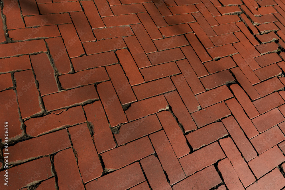 Old weathered and broken chipped brick road from naturally shiny brick ...