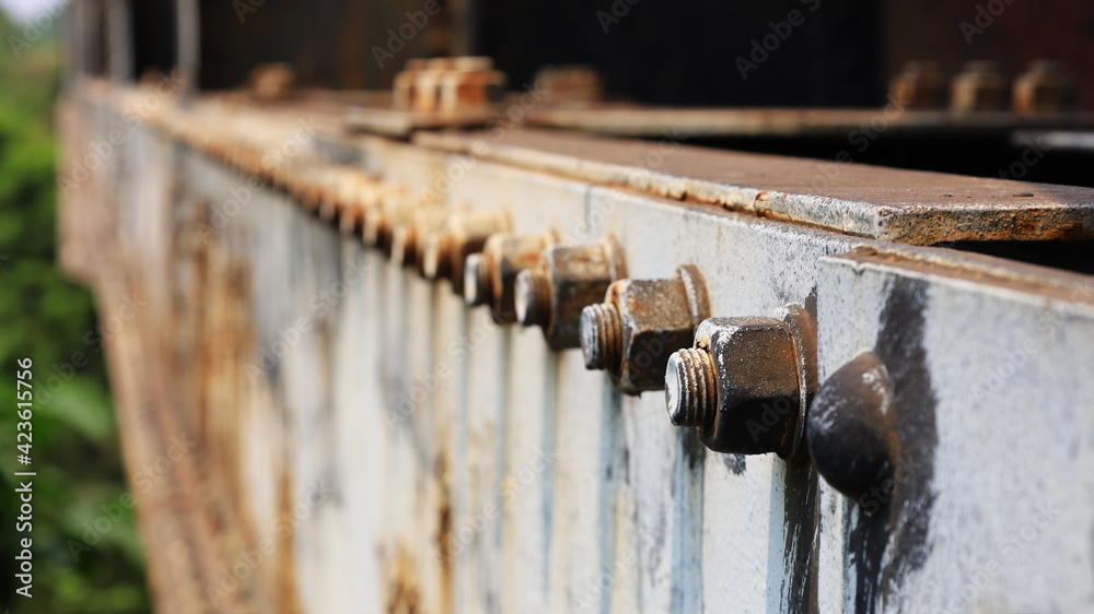 Rusted nuts and bolts on the old bridge. On the gray steel beam there ...