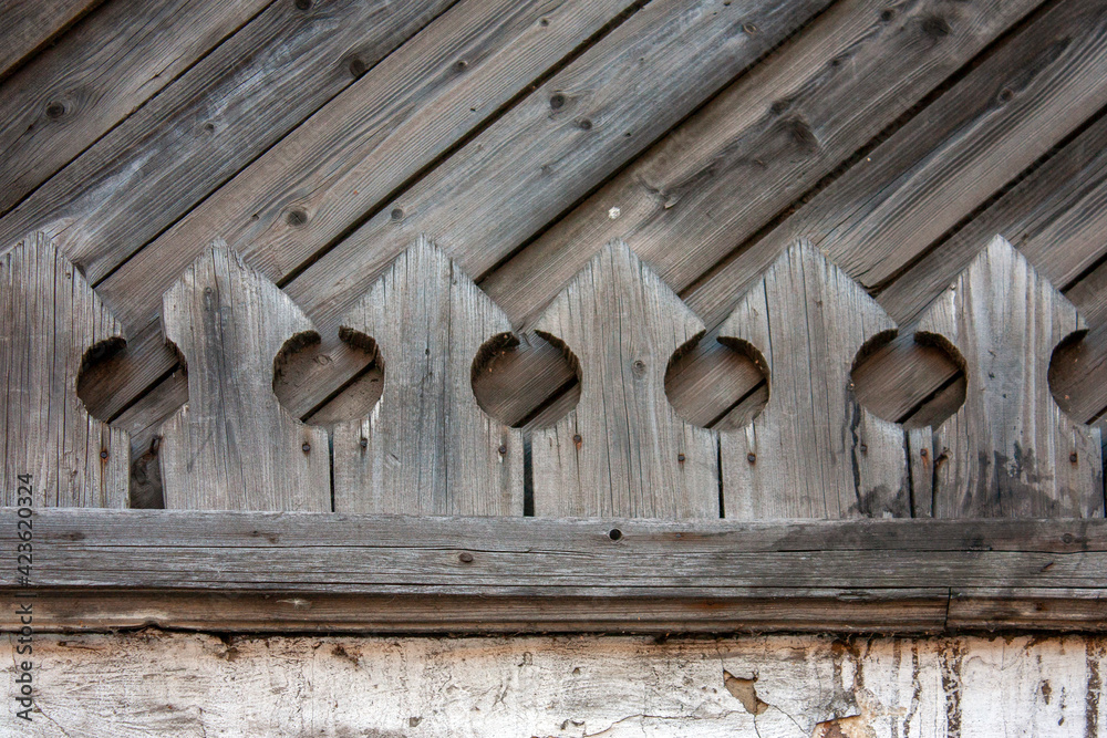 The wall is planked diagonally boards. The edge of the wooden wall is ...