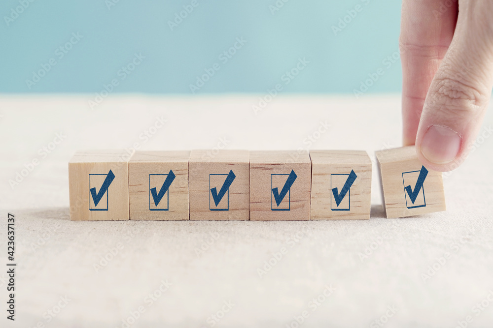 Hand holding wooden block with tick mark, good feedback rating and ...