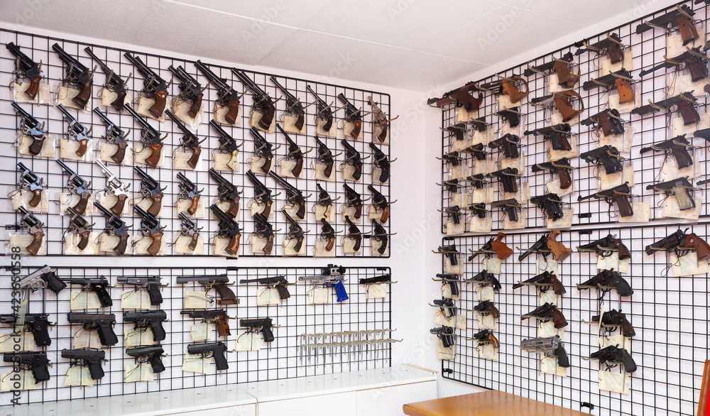 Large assortment of modern pistols for sale on display of gun shop ...