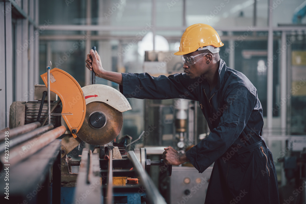 Foto de Factory engineer wearing safety uniform control operating lathe ...