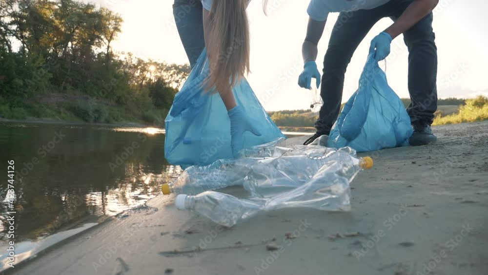 Plastic waste environmental pollution concept. Teamwork of volunteers ...