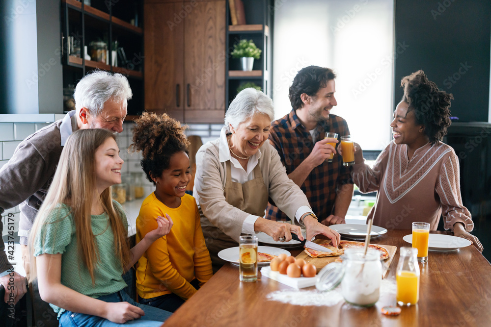 Multi ethnic and generational family cooking in kitchen together Stock ...