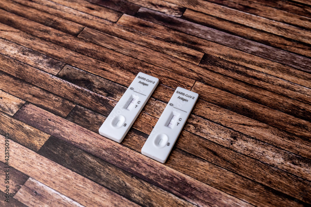 two Covid 19 antigen saliva tests with negative and positive result are ...