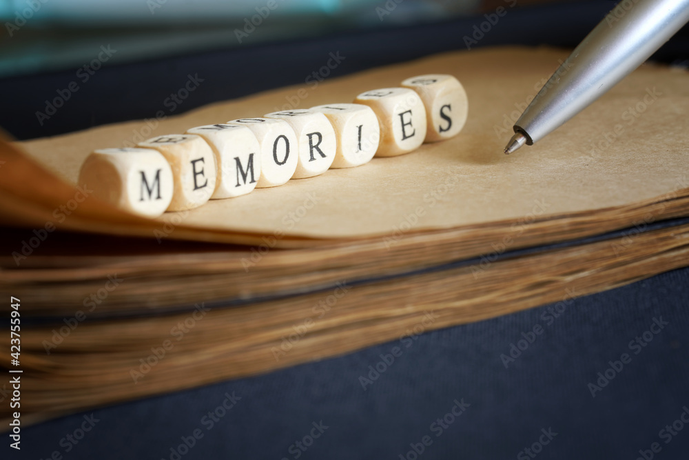 A ballpoint pen writes memories in an eco-friendly notebook. Concept ...