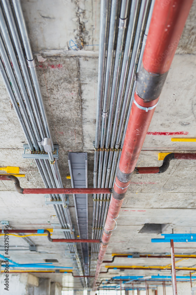 Fire sprinkler system with red pipes is placed to hanging from the ...