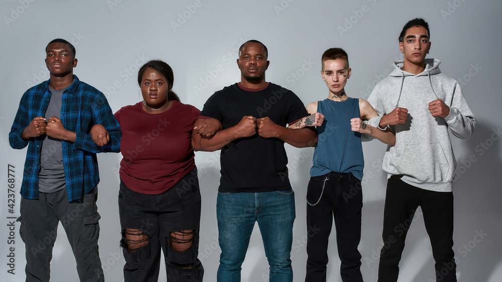 Young crowd standing side by side holding hands Stock Photo | Adobe Stock