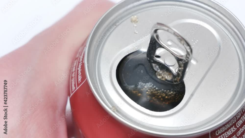 Hand opening a simple 330 ml metal can of soda, macro, extreme closeup ...