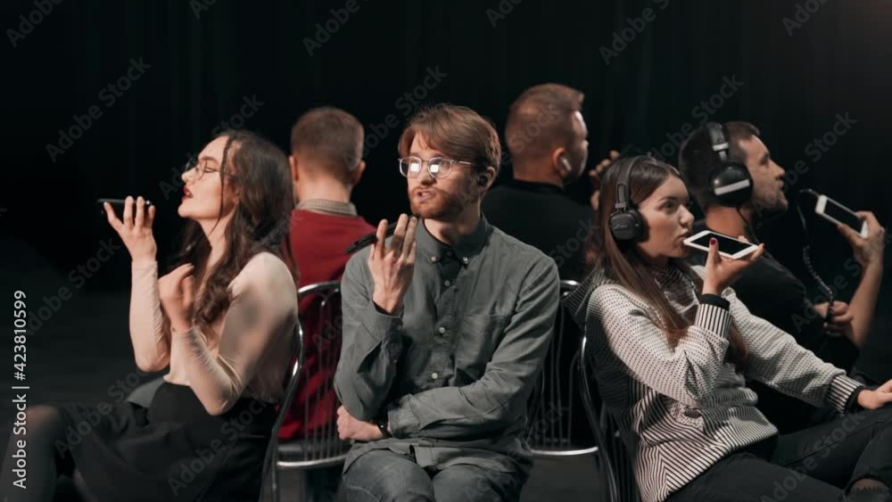group of people sitting in a circle with their backs to each other in ...