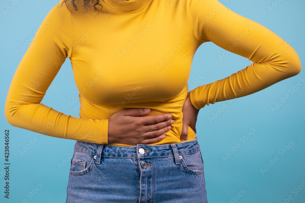 Woman squeezing belly with hands because of abdominal pain. Lady ...