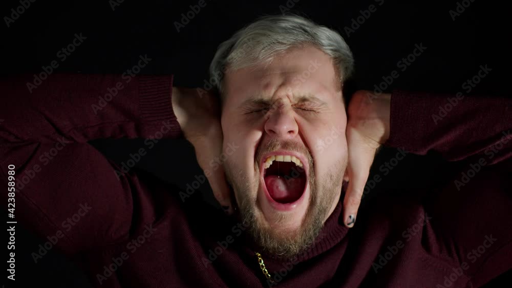 Frightened stylish young man scared fearful, covering ears with hands ...