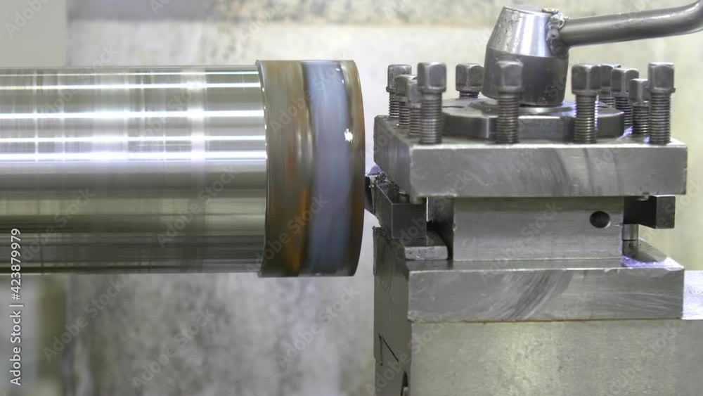 The operation of lathe machine cutting the metal shaft parts. The ...
