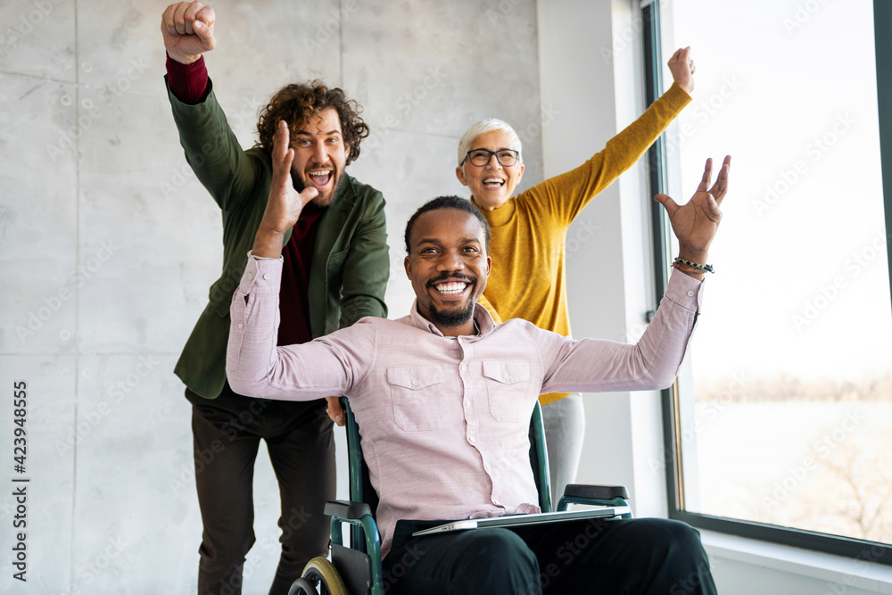 Business people with disability in wheelchair working together in ...