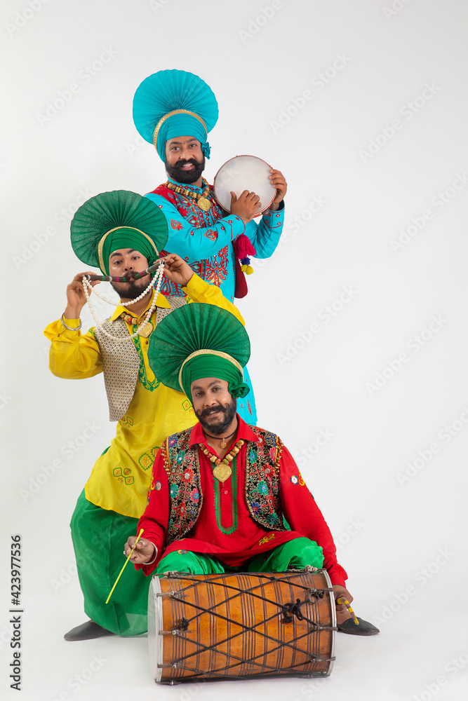 Three Bhangra Dancers playing Dafli,Dhol and Alghoza. Stock Photo ...