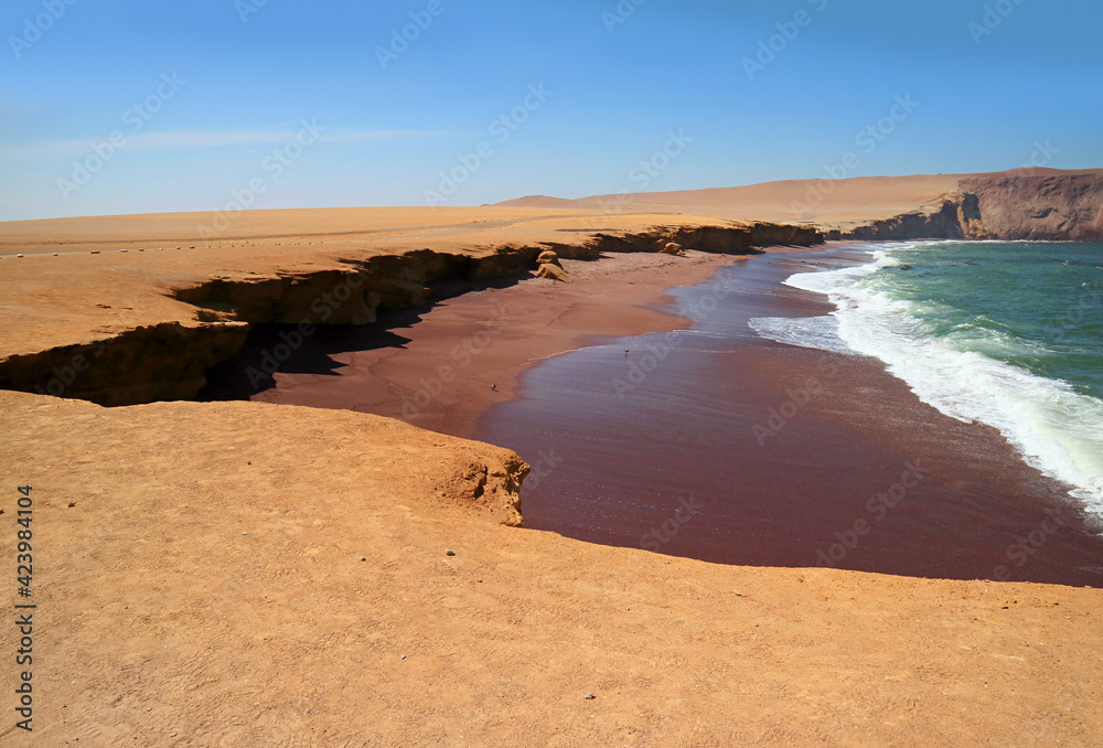 The Red Beach or Playa Roja with white wave foam from the Pacific ocean ...
