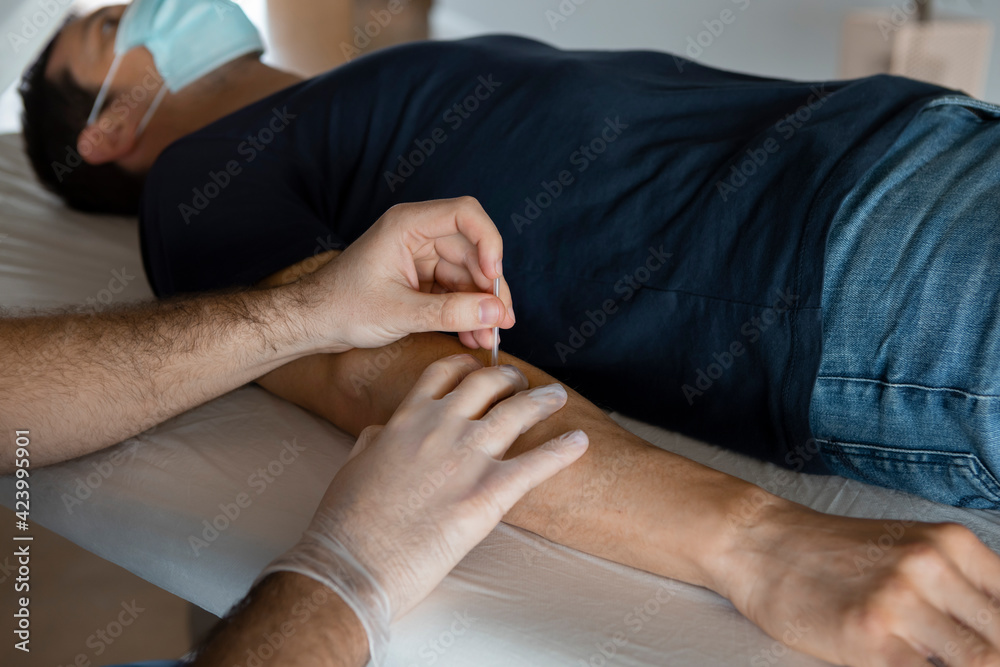 Close up of Physiotherapist hands with surgical gloves introducing a ...