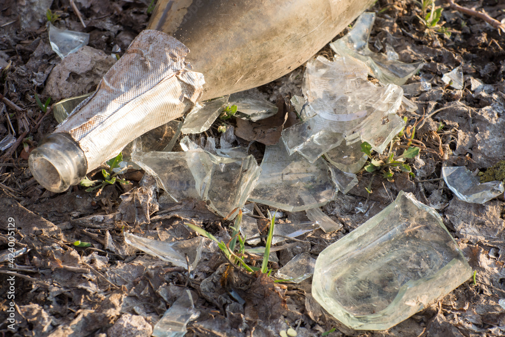 Broken glass trash on the ground. The problem of pollution of nature ...