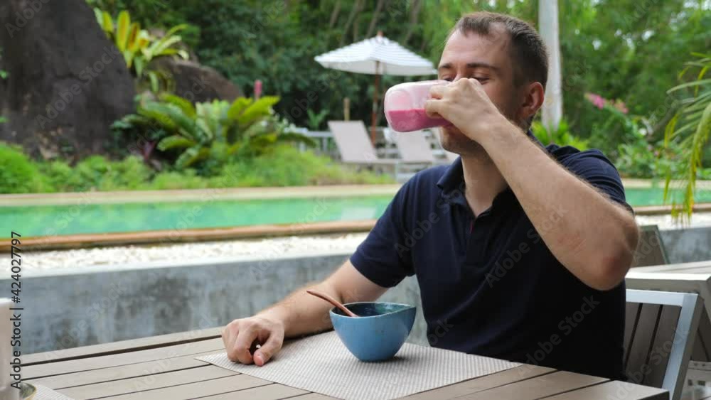 Happy Handsome Man Drinking Shake from Fresh Fruit and Berries at ...