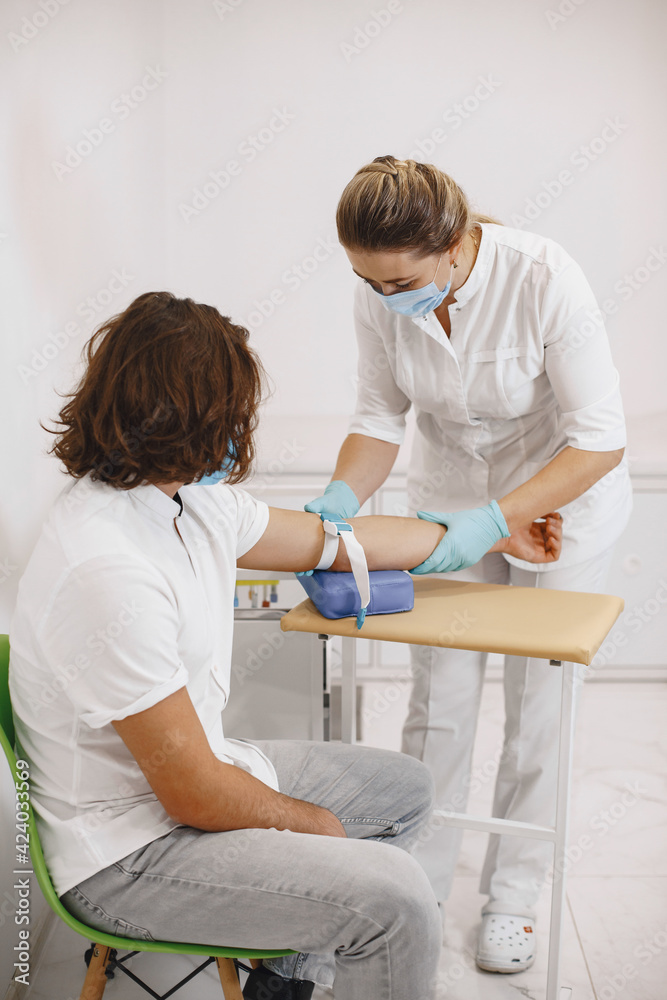 Nurse taking blood sample from patient at the doctors office Stock ...