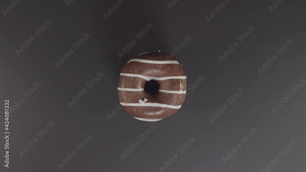 Eating pile of colorful donuts, overhead view of male hand grabbing ...