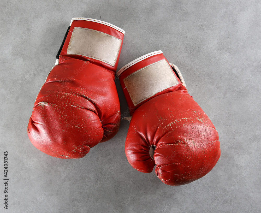 Boxing gloves on the gym floor after training. Gray grunge concrete ...