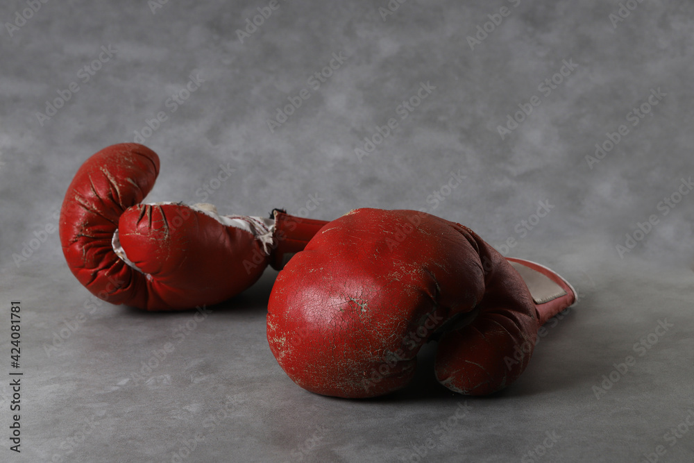 Boxing gloves on the gym floor after training. Gray grunge concrete ...
