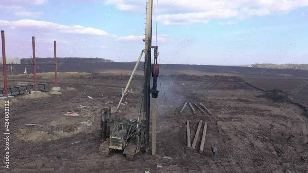Excavation at a construction site, diesel pile driving machine with ...