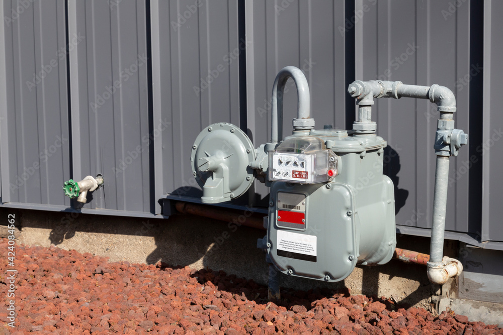 An angular view of a residential gas meter and pressure regulator ...