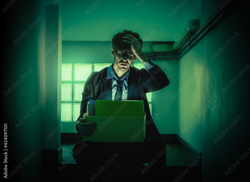 Depressed Umemployed Business office worker is sitting with card box in ...