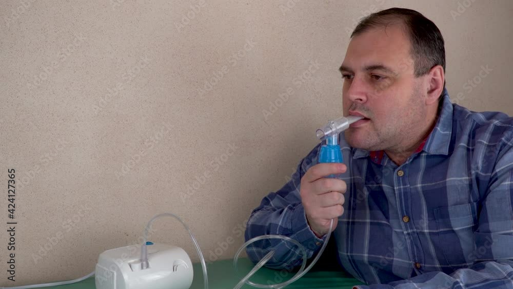 Video Stock adult person makes inhalations with the help of nebulizer ...