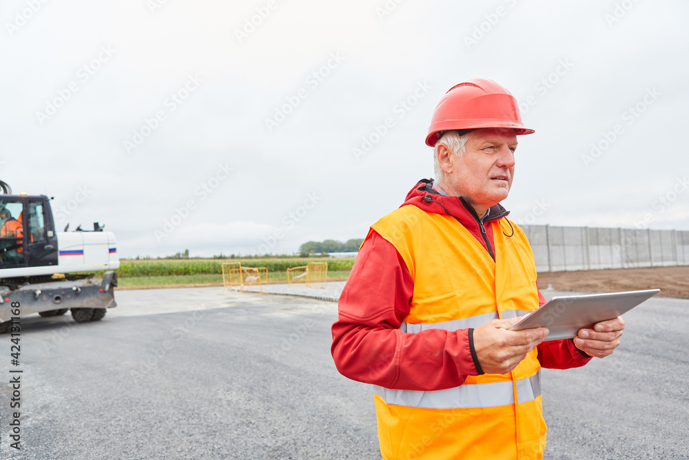 Construction manager and architect with tablet PC in road construction ...