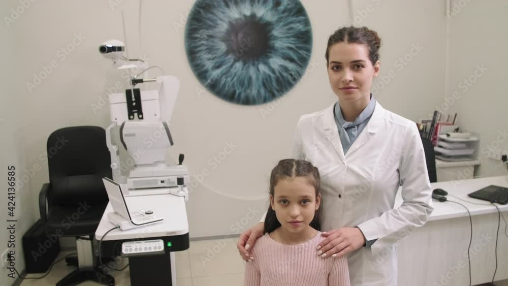 Slow-motion medium PAN portrait of little girl and professional female ...