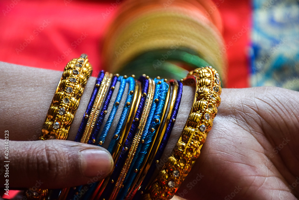 Stock photo of a hand of Indian women wearing colorful bangles with ...