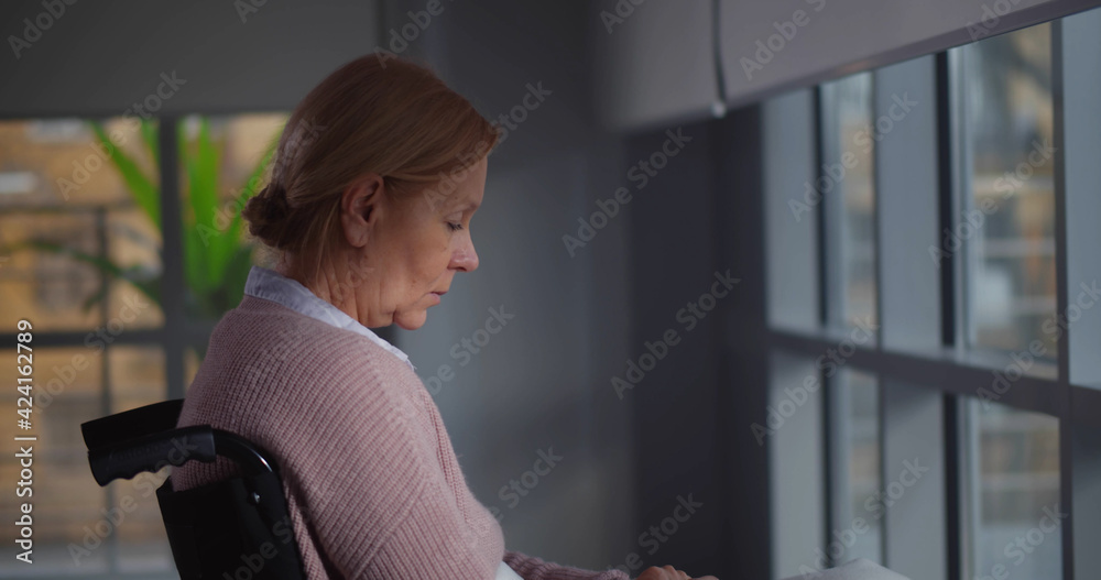 Sad handicapped elderly woman seated in wheelchair crying Stock Photo ...