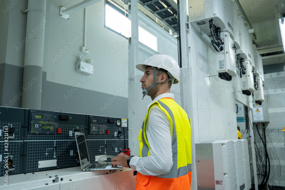 Electrical engineer working on the tablet and recording the voltage ...