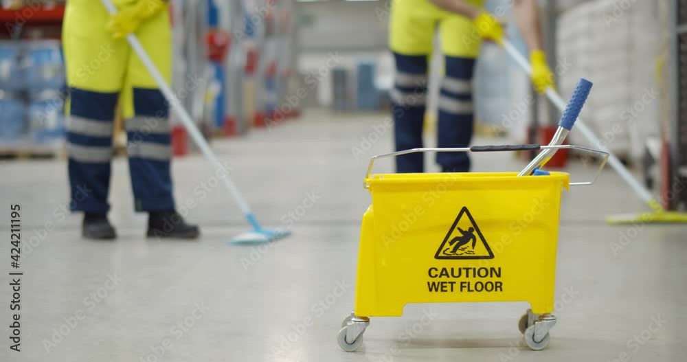 Cropped shot of worker swearing safety overall holding mop cleaning ...