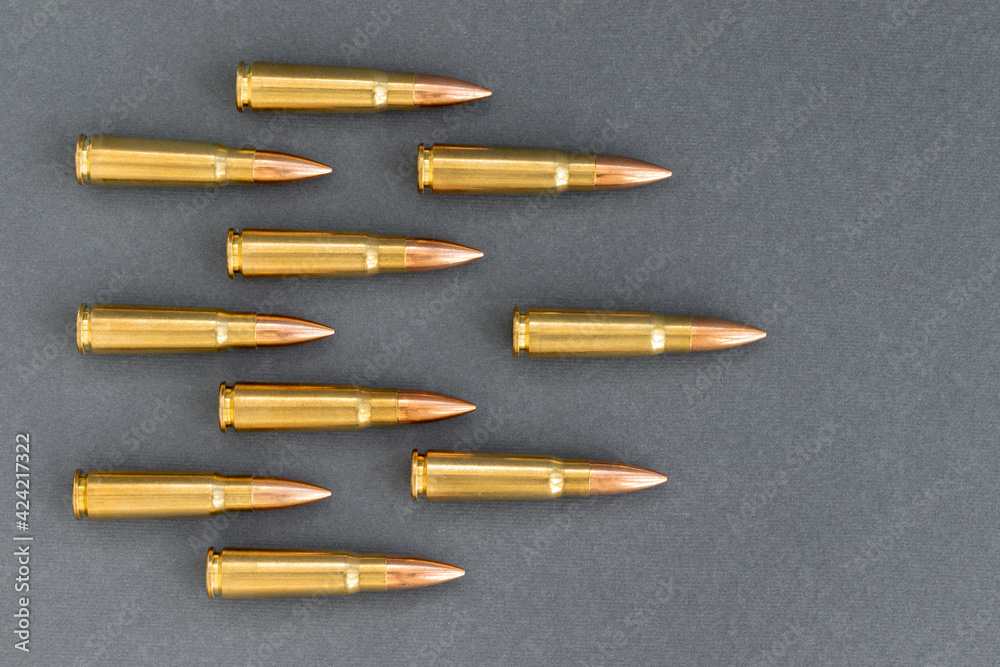 Bullets on gray paper background. Cartridges 7.62 caliber for ...