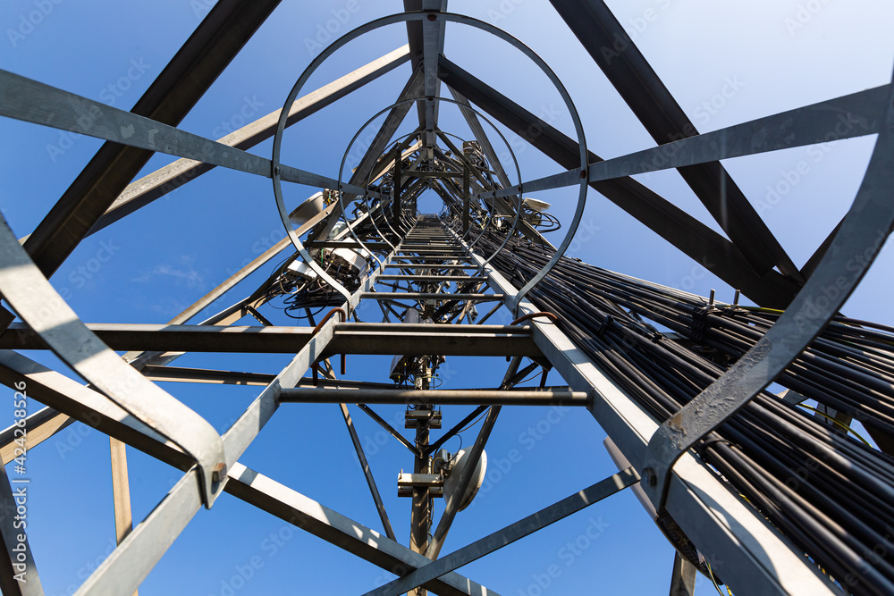 Telecommunication tower with microwave equipment, radio panel antennas ...