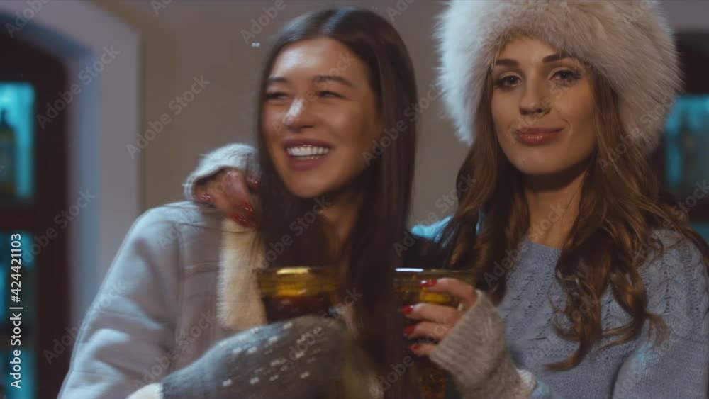 Two cheerful girls hugging one girl kissing her best female friend on ...