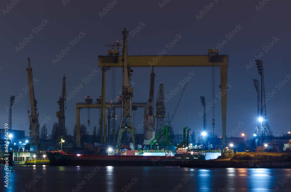 SHIPYARD AT NIGHT - Ship at the quay and a slipway with cranes Stock ...