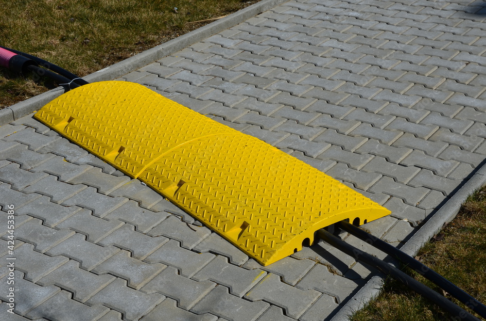 connecting electricity cables through walking paved sidewalk road. a ...