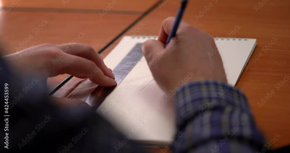 The artist drawing a flat line with a black pencil. Artists hands ...